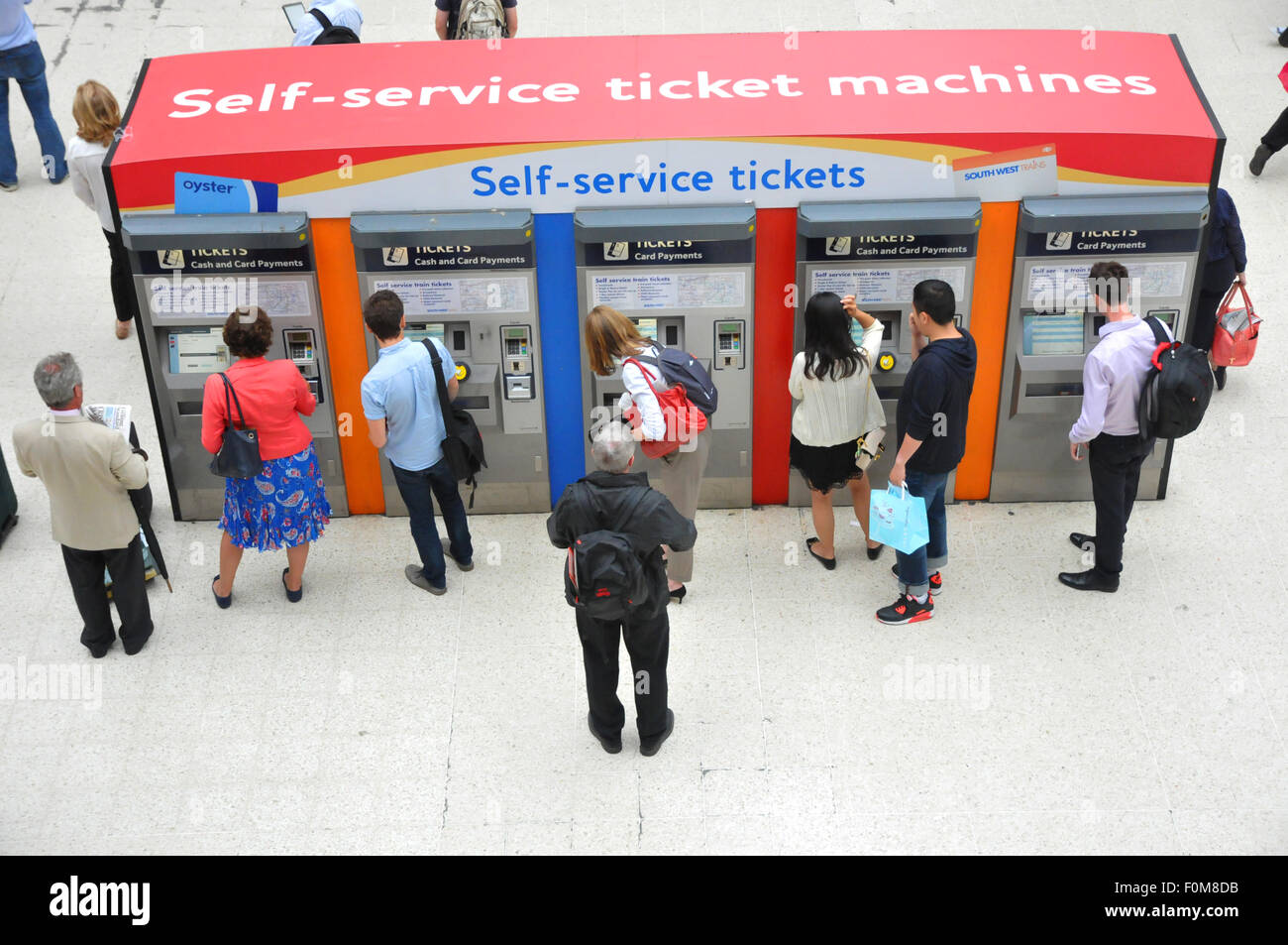 image from above of people buying train tickets Stock Photo - Alamy