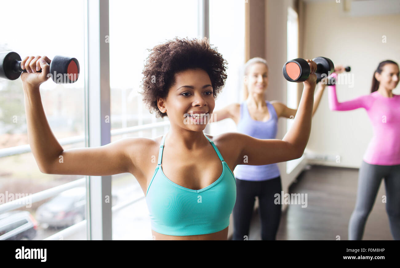 group of happy women with dumbbells in gym Stock Photo - Alamy