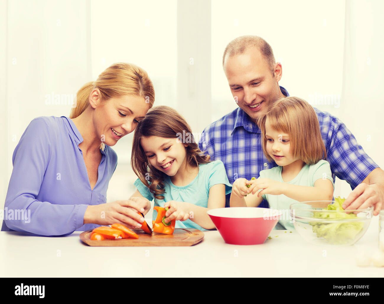 happy family with two kids making dinner at home Stock Photo - Alamy