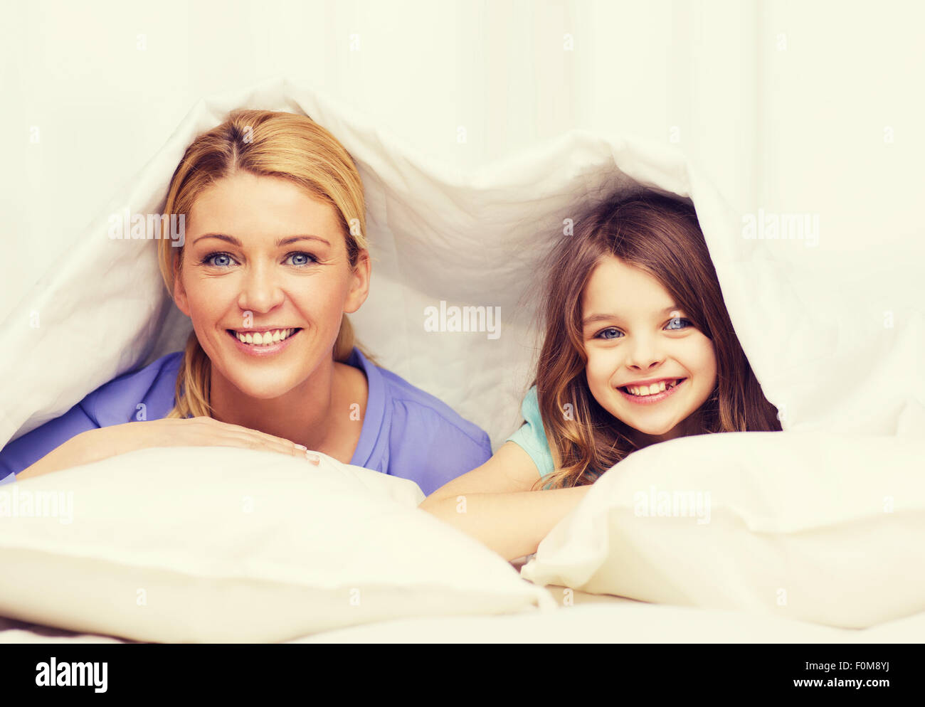 mother and little girl under blanket at home Stock Photo - Alamy