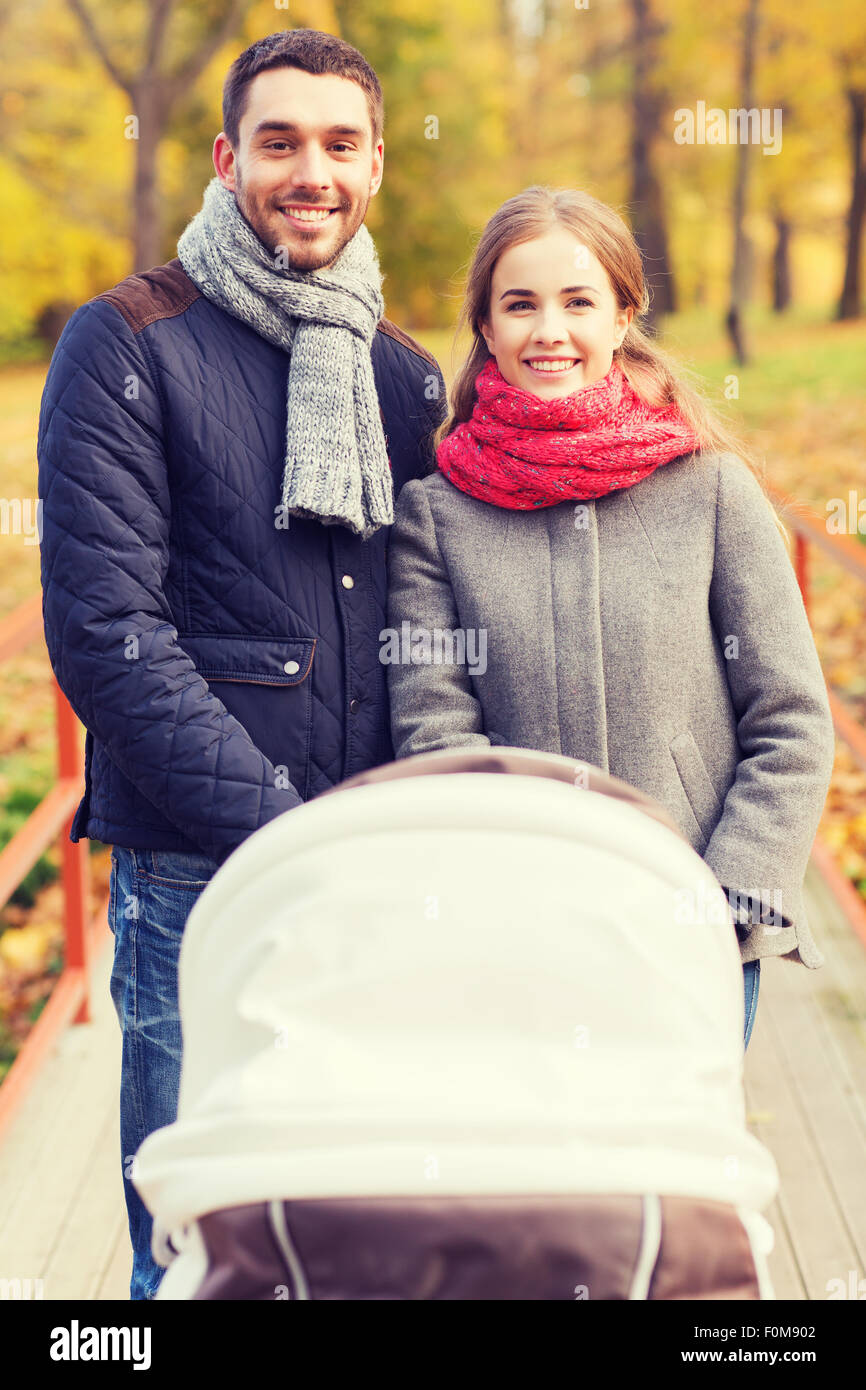 smiling couple with baby pram in autumn park Stock Photo - Alamy