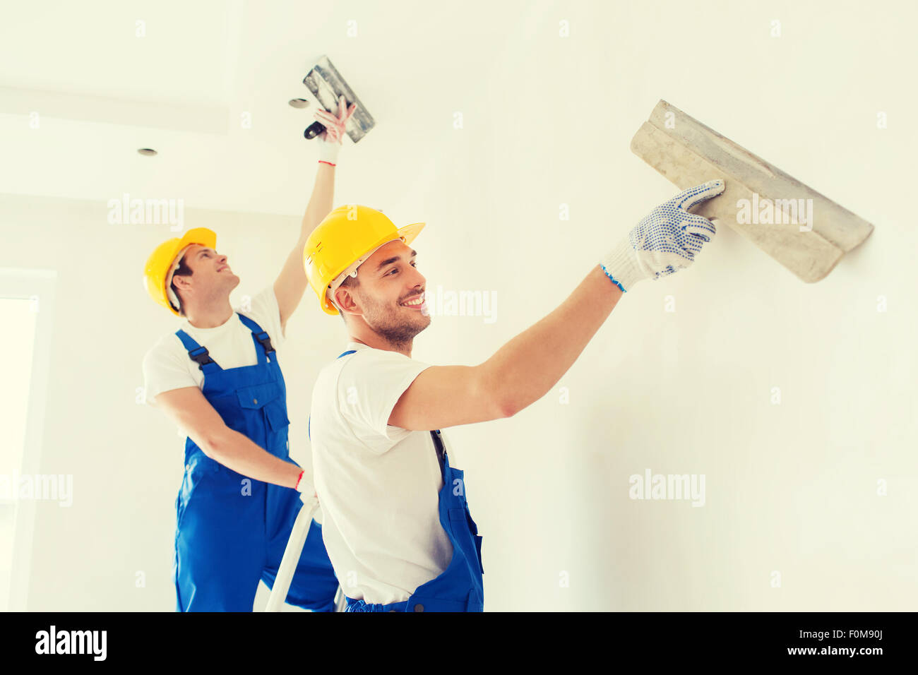 group of builders with tools indoors Stock Photo - Alamy