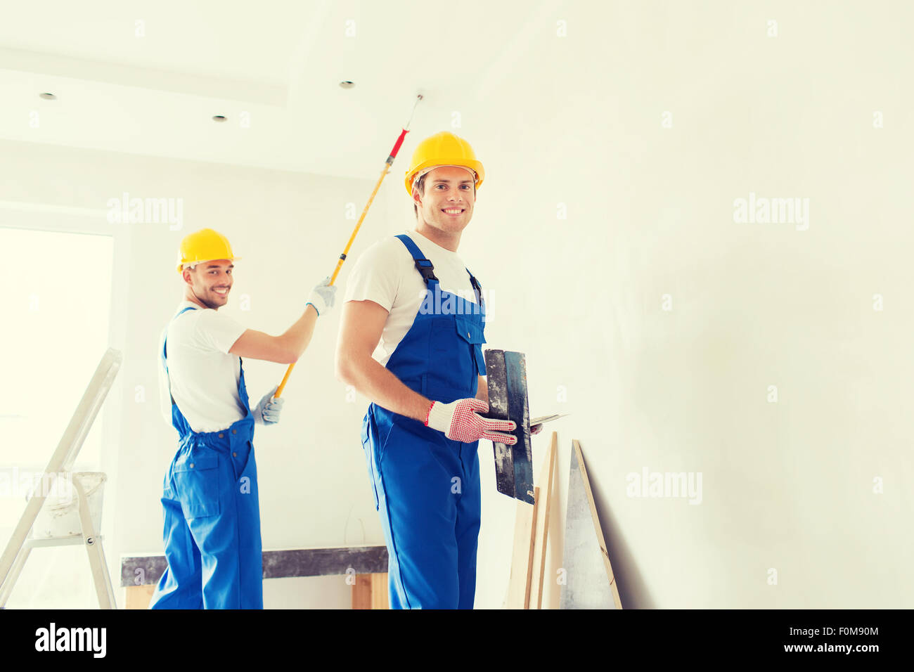 group of builders with tools indoors Stock Photo - Alamy