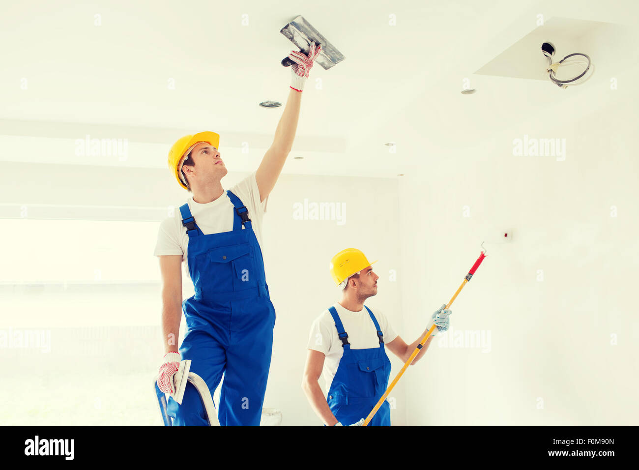 group of builders with tools indoors Stock Photo - Alamy