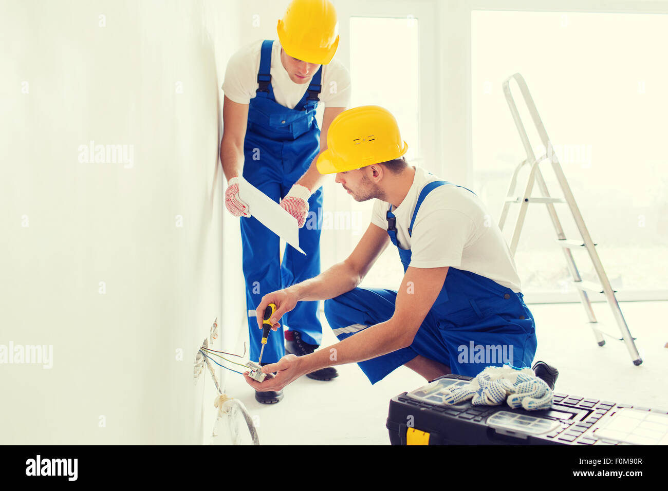 builders with tablet pc and equipment indoors Stock Photo - Alamy