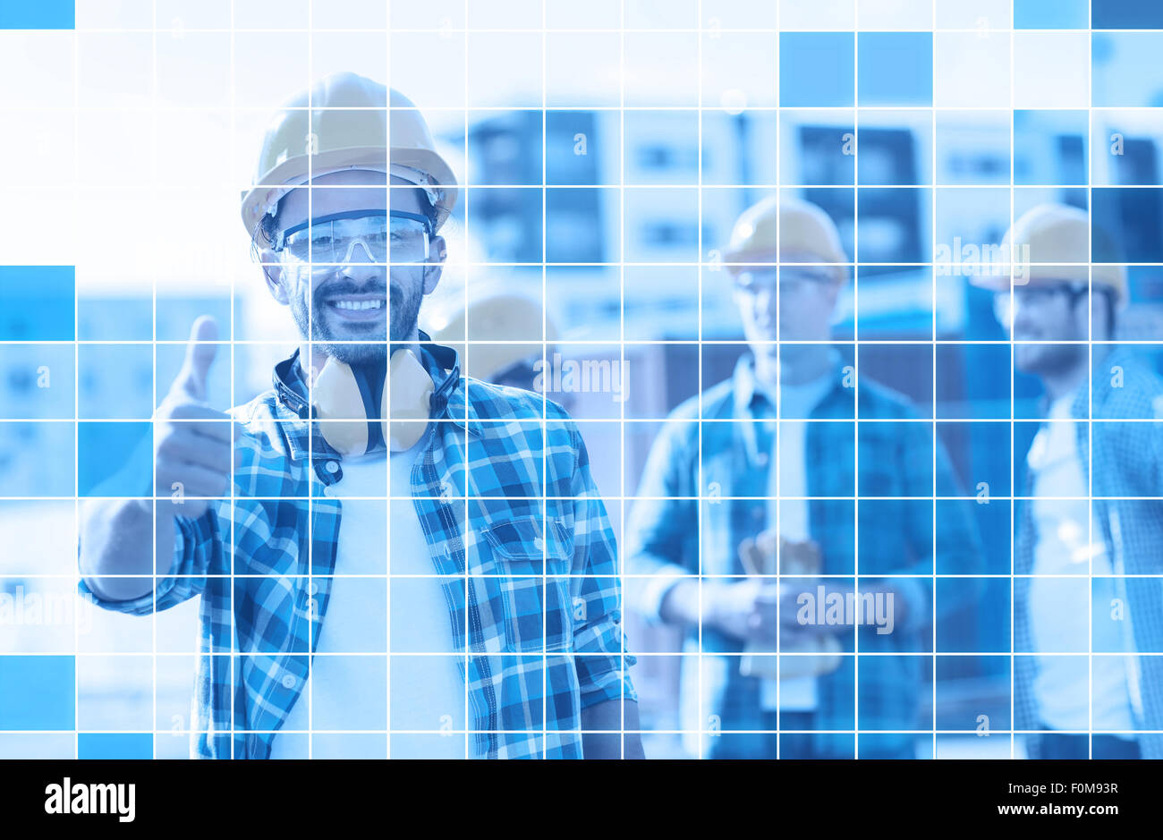 group of smiling builders in hardhats outdoors Stock Photo - Alamy