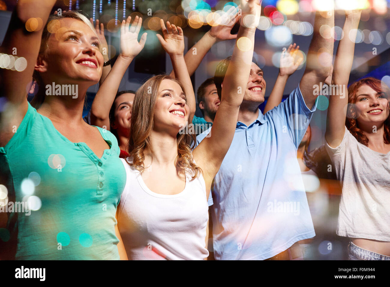 smiling friends at concert in club Stock Photo - Alamy