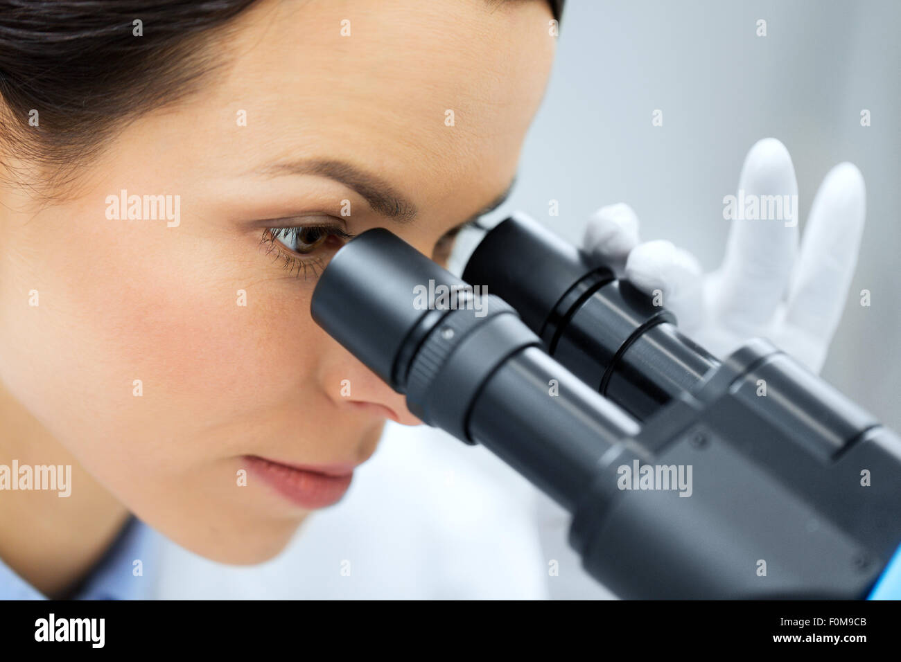 close up of scientist looking to microscope in lab Stock Photo - Alamy