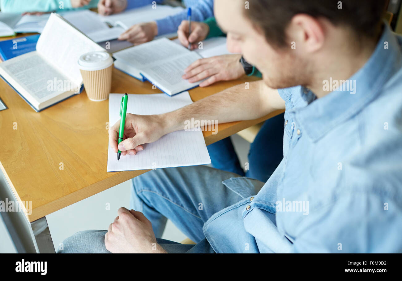 happy students writing to notebooks in library Stock Photo - Alamy