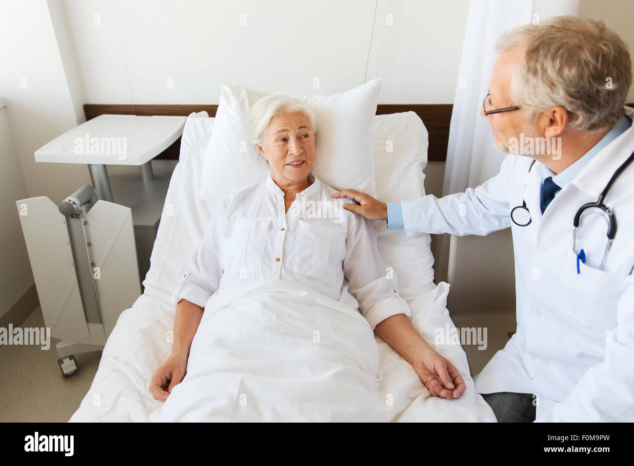Senior woman visiting doctor hi-res stock photography and images - Alamy