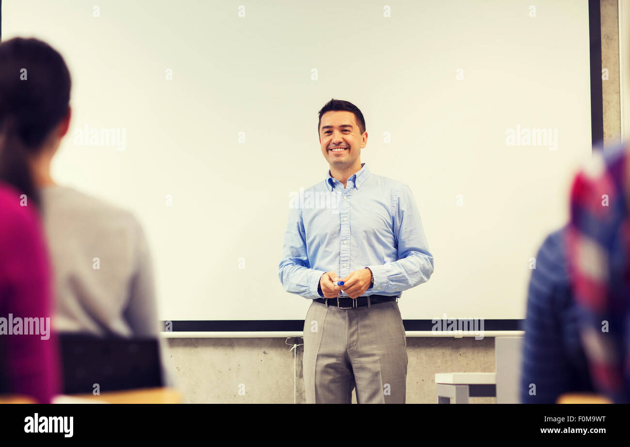 group of students and smiling teacher in classroom Stock Photo - Alamy