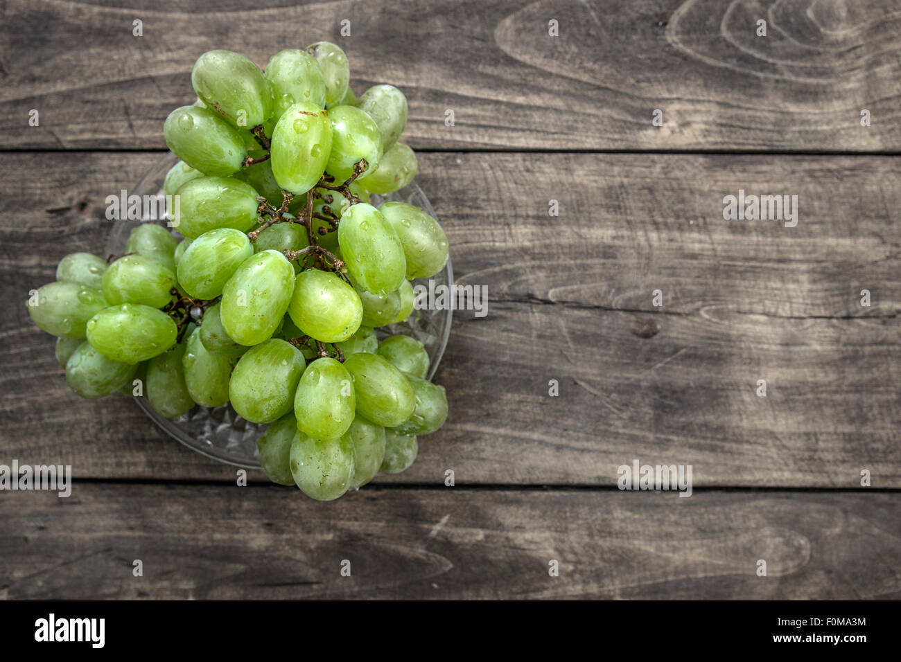 White grapes on wooden table, from above Stock Photo - Alamy