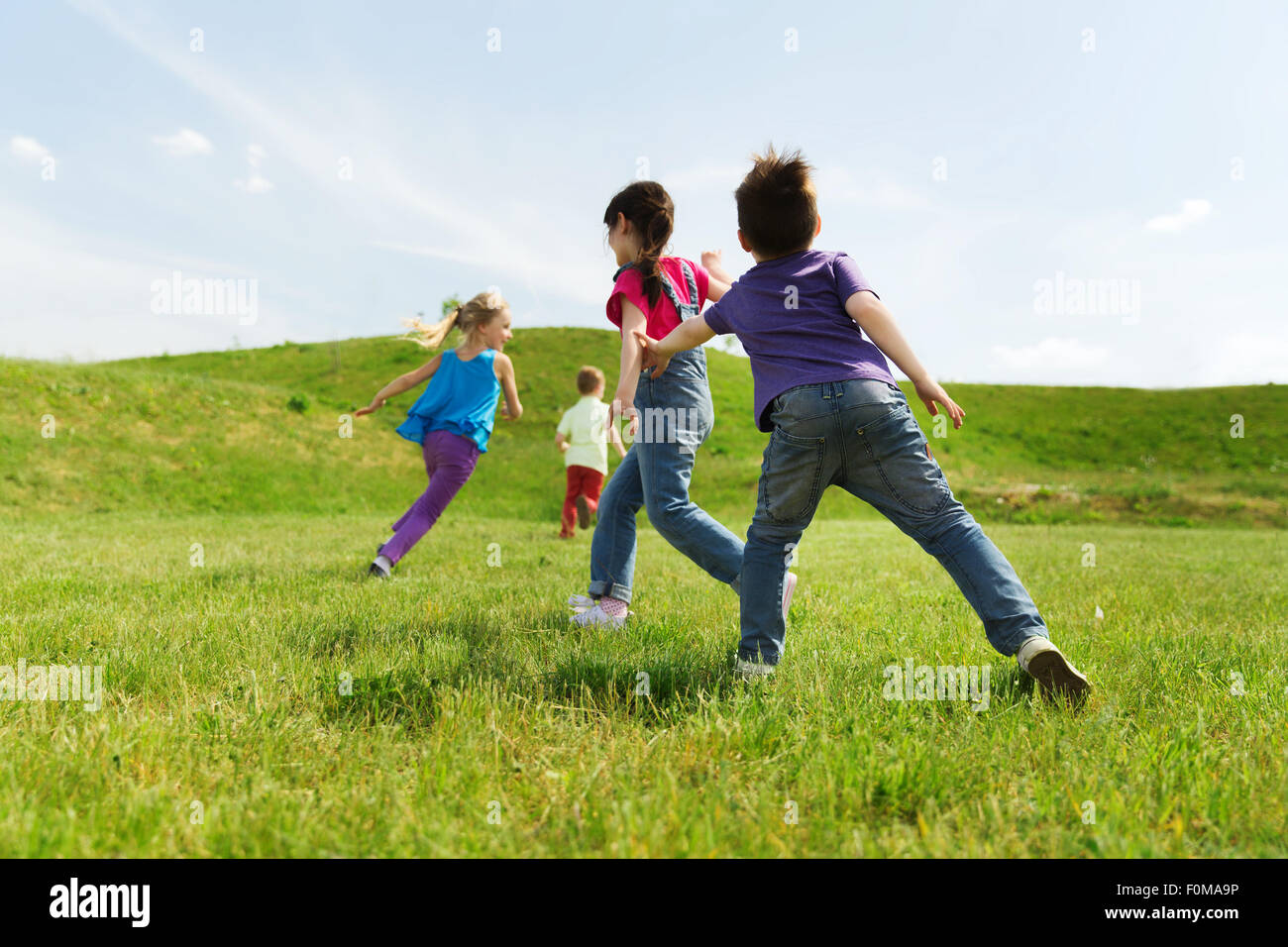 group of happy kids running outdoors Stock Photo - Alamy