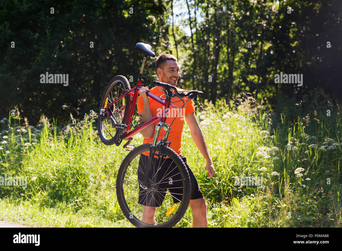 happy young man riding bicycle outdoors Stock Photo - Alamy