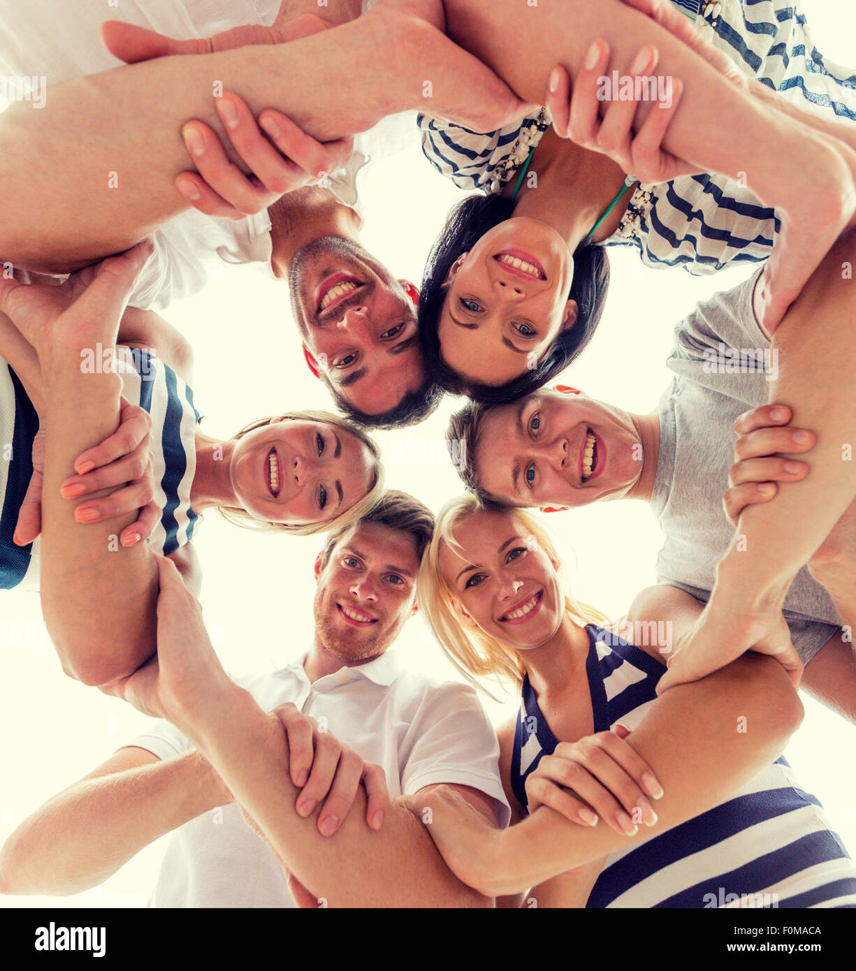 smiling friends in circle Stock Photo - Alamy