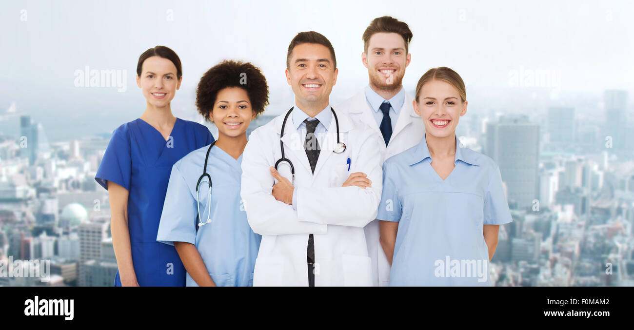 group of happy doctors over blue background Stock Photo - Alamy