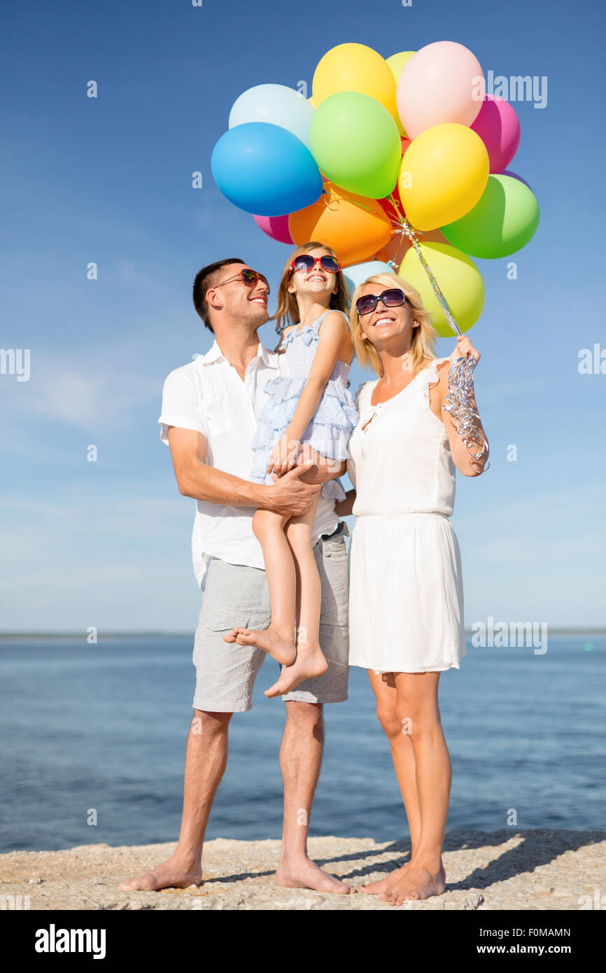 happy family with colorful balloons at seaside Stock Photo - Alamy