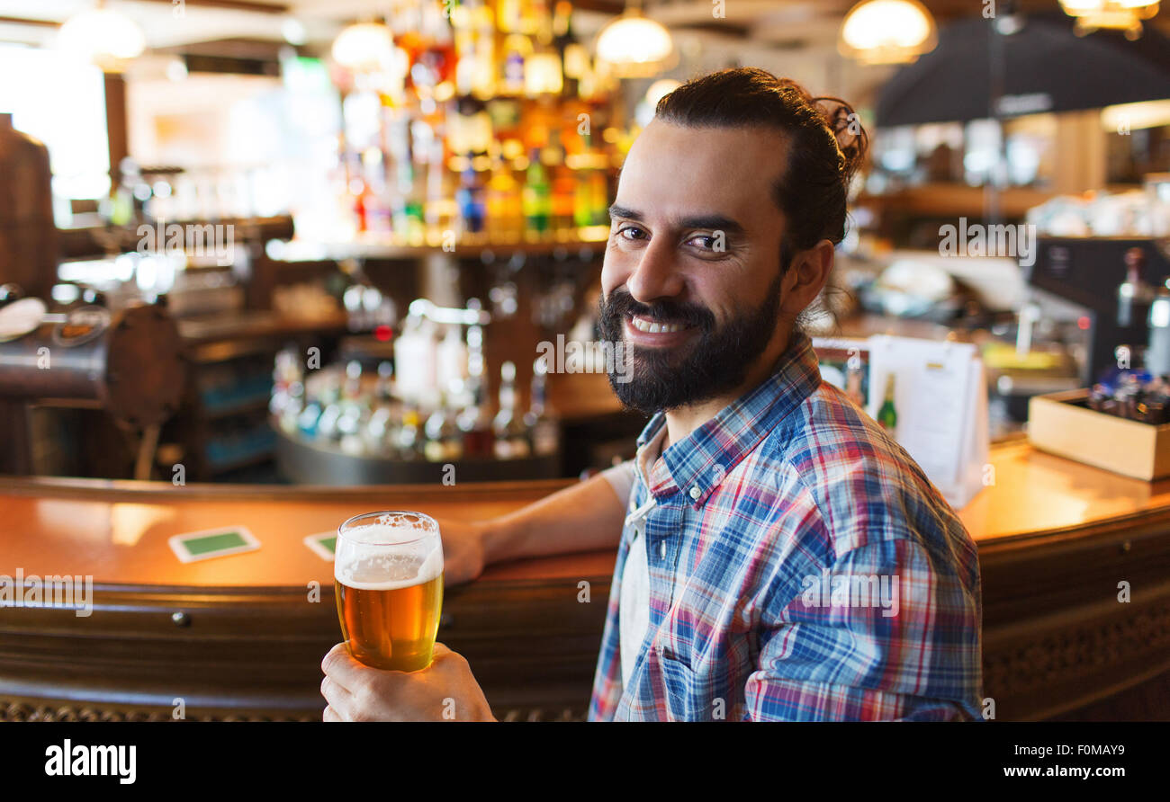 happy man drinking beer at bar or pub Stock Photo - Alamy