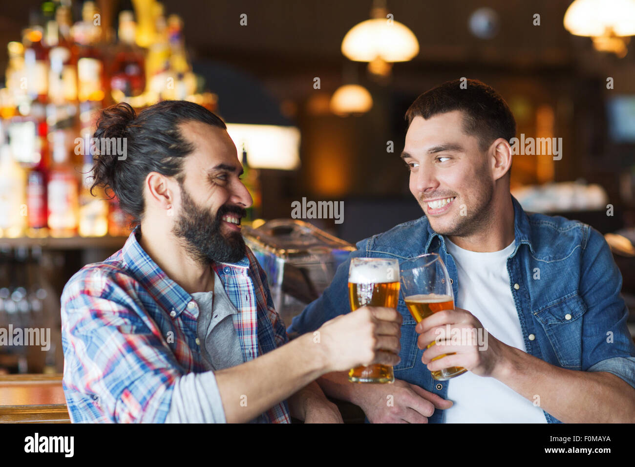 happy male friends drinking beer at bar or pub Stock Photo - Alamy