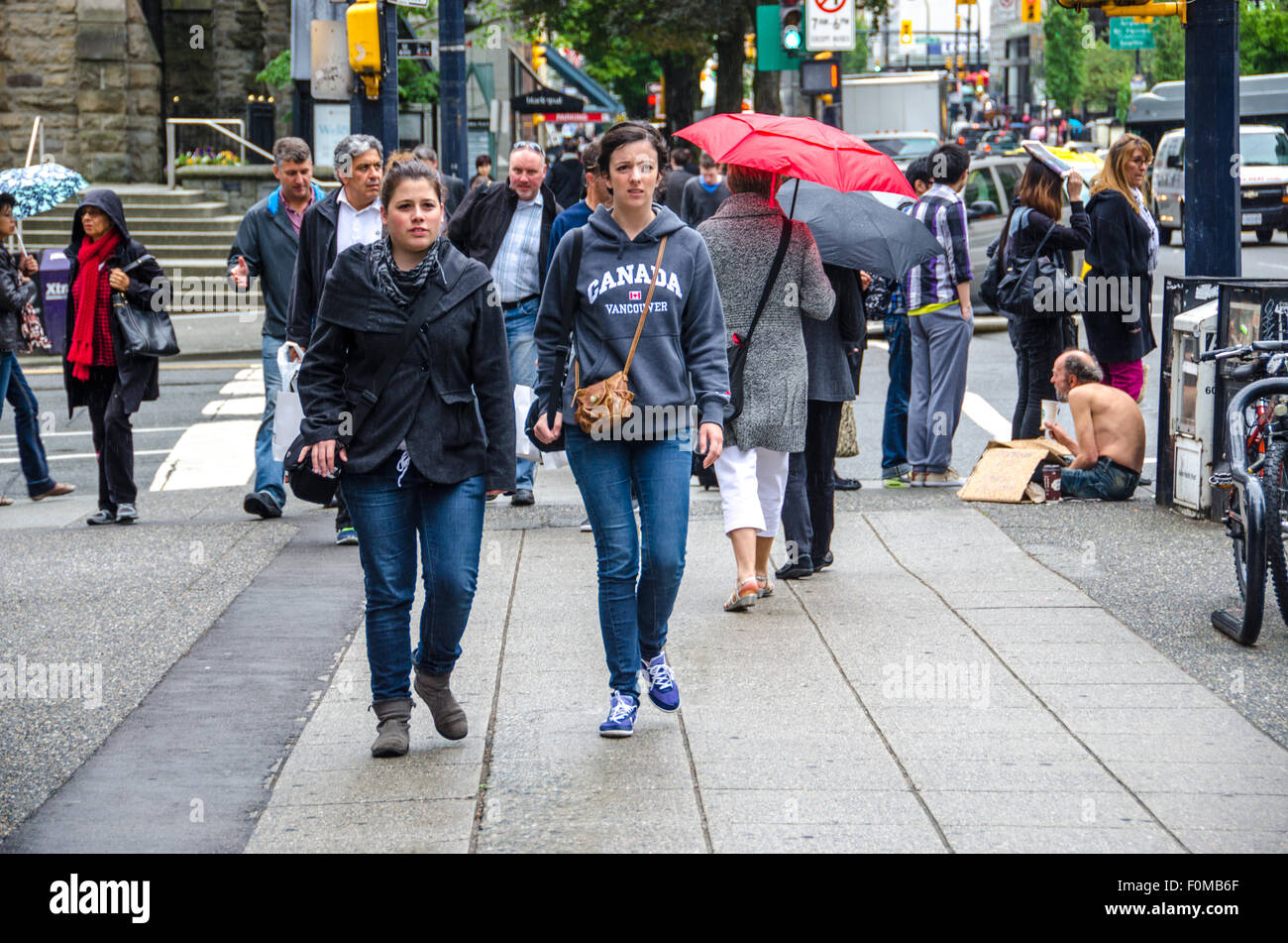 People walking around a homeless Stock Photo - Alamy