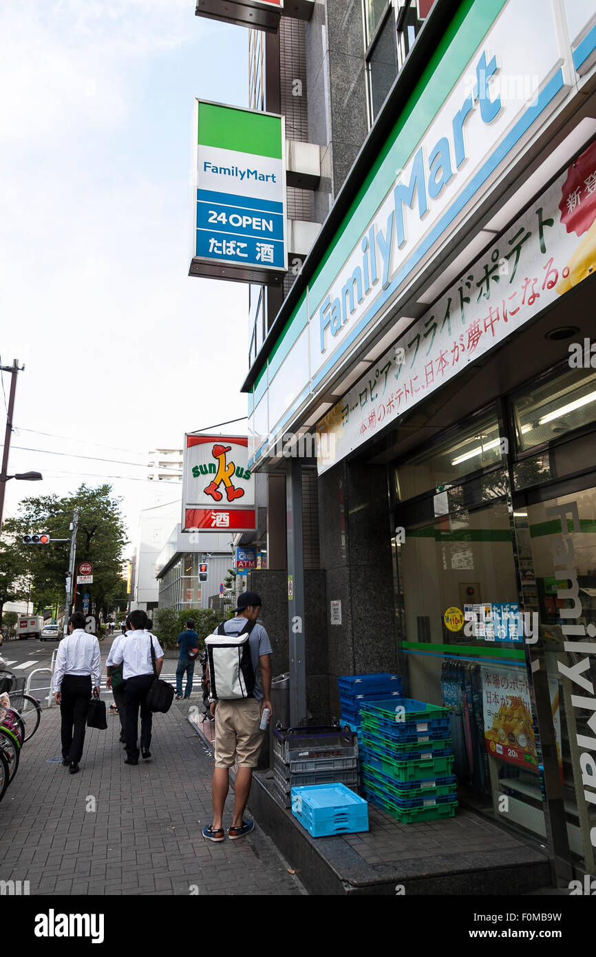 FamilyMart and Sunkus signboards on display at the entrance of their ...