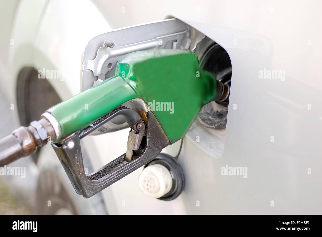 Green refueling hose inside a car's fuel tank Stock Photo - Alamy