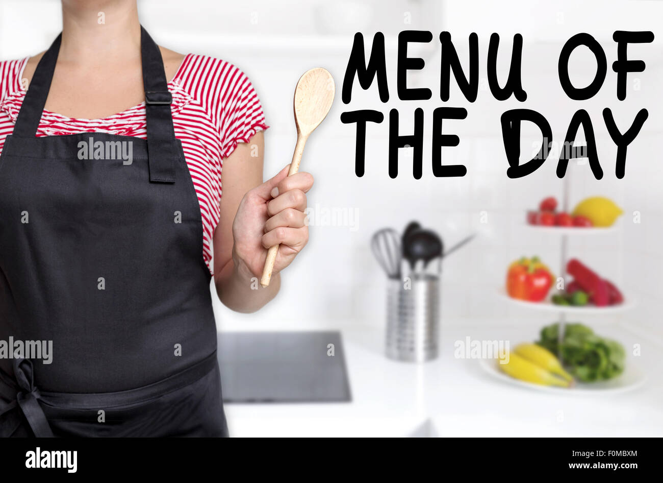 Menu of the day cook holding wooden spoon background Stock Photo - Alamy