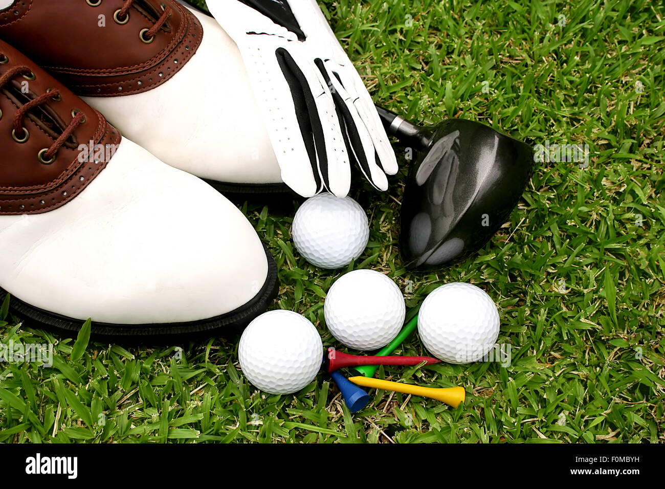 Several golf items over the green grass of the fairway Stock Photo - Alamy