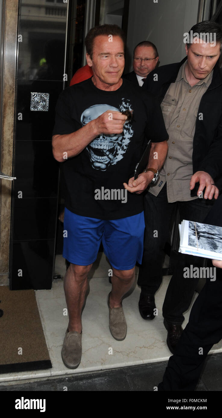 Arnold Schwarzenegger signs for fans as he leaves Claridges Featuring ...