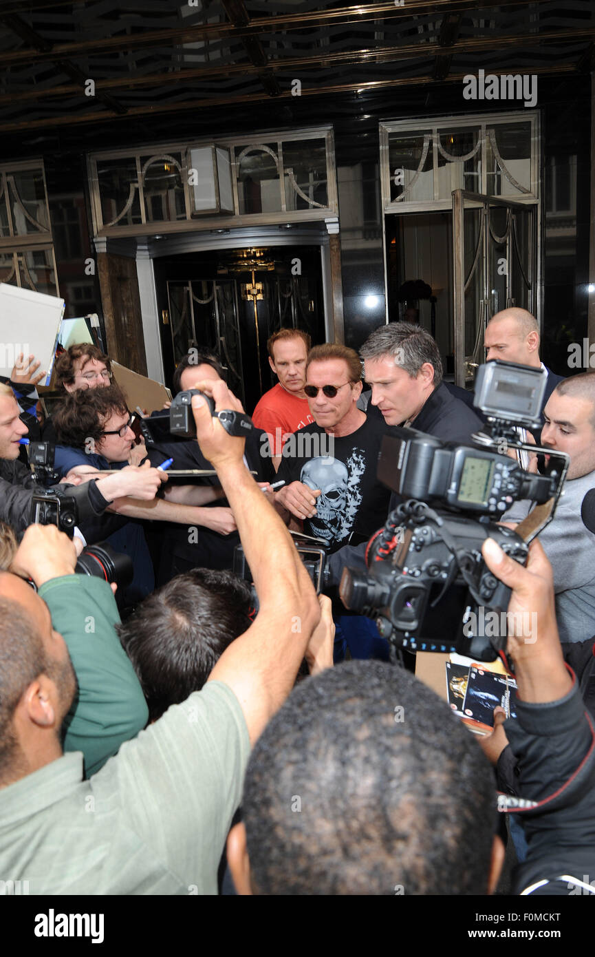 Arnold Schwarzenegger signs for fans as he leaves Claridges Featuring ...