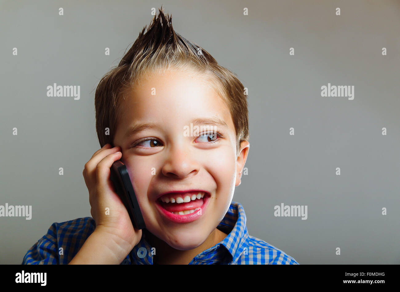 Sweet little boy talking using cell phone Stock Photo - Alamy
