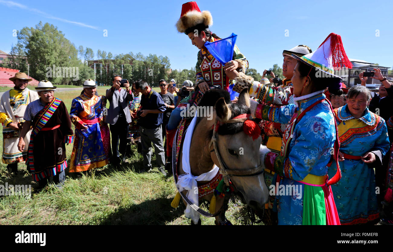 Zhangye. 18th Aug, 2015. The bride mounts the horse at a traditional ...