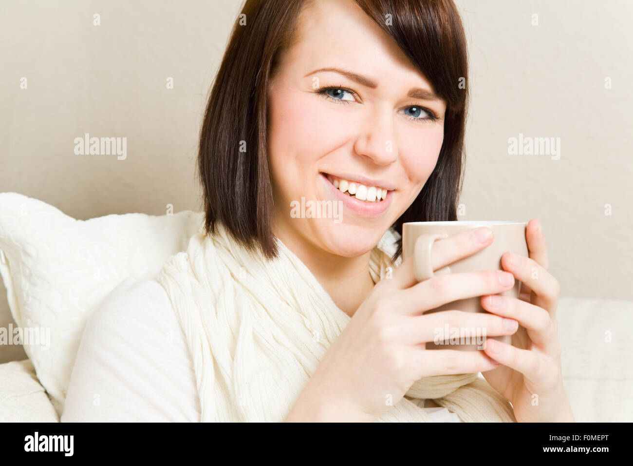 Young woman drinking hot tea Stock Photo - Alamy