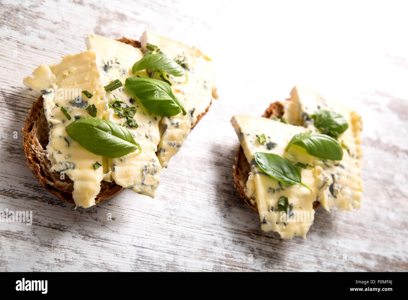 European style sandwiches with Roquefort cheese and Basil leaves on ...
