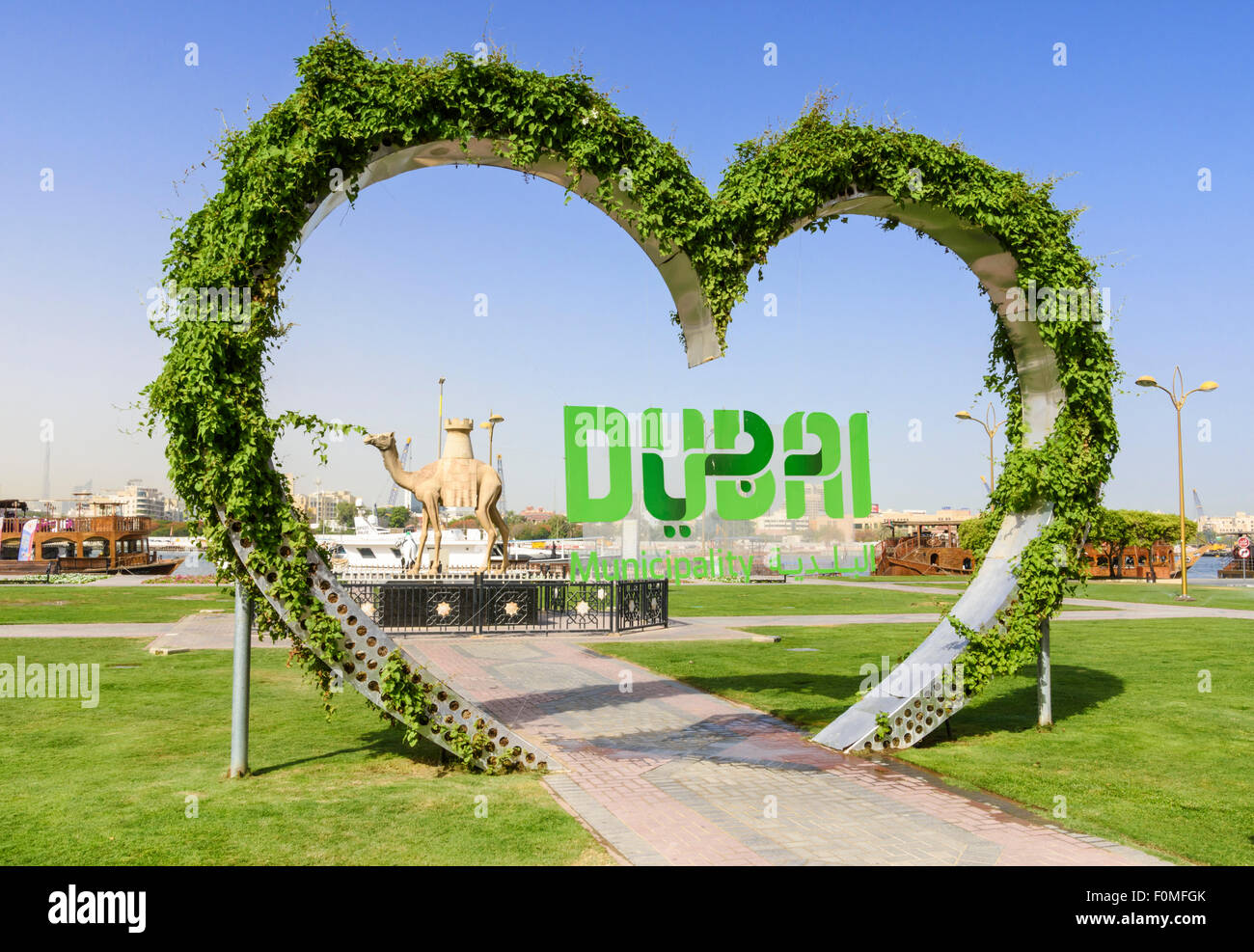 Love heart framed Dubai Municipality sign and statue of a camel along ...