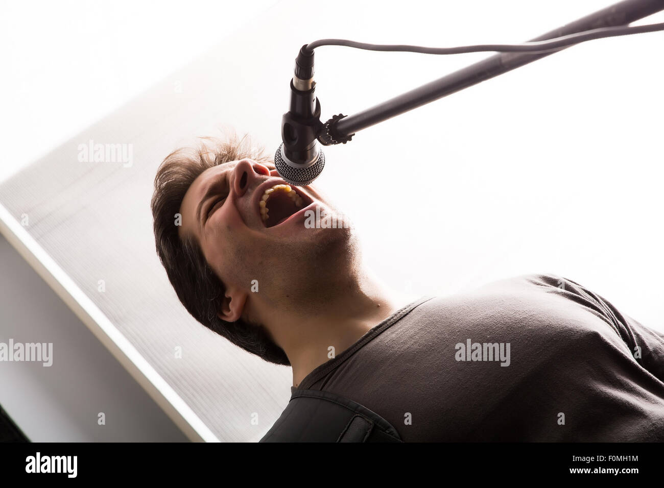 Portrait of a Rock singer playing bass in the rehearsal Studio Stock ...