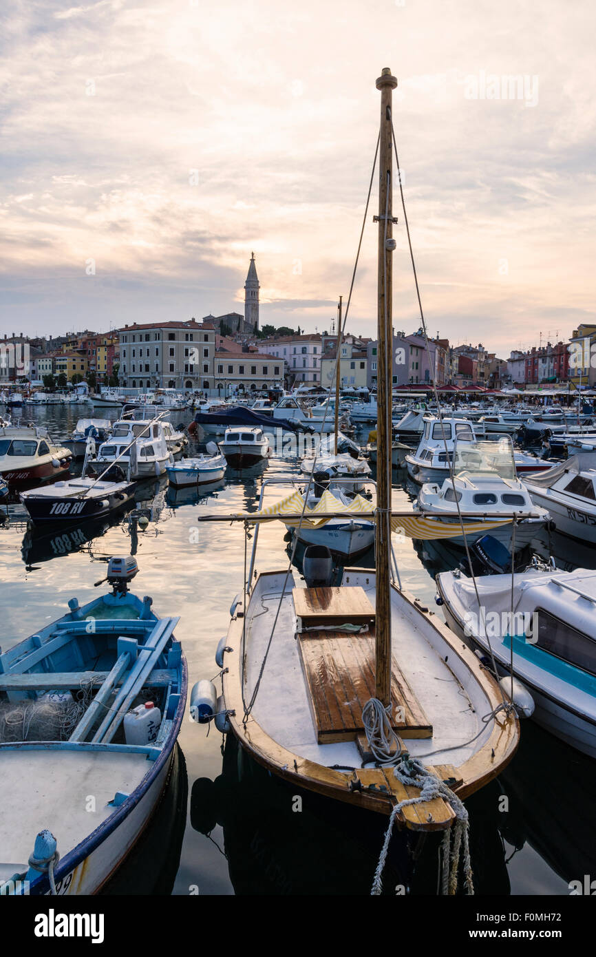 Sunset over small boats anchored below the Church of St Euphemia ...