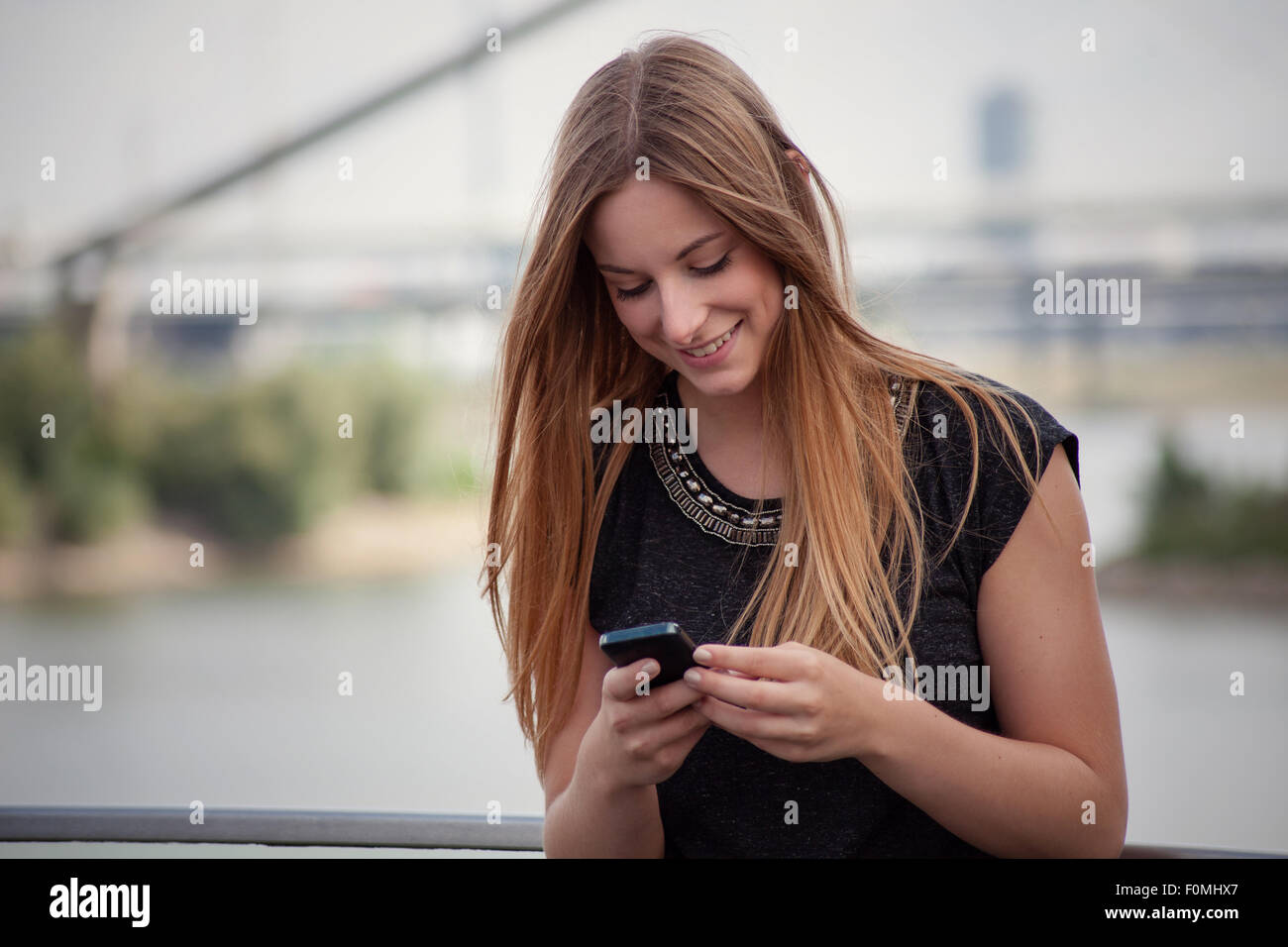 Attractive girl using smart phone Stock Photo - Alamy