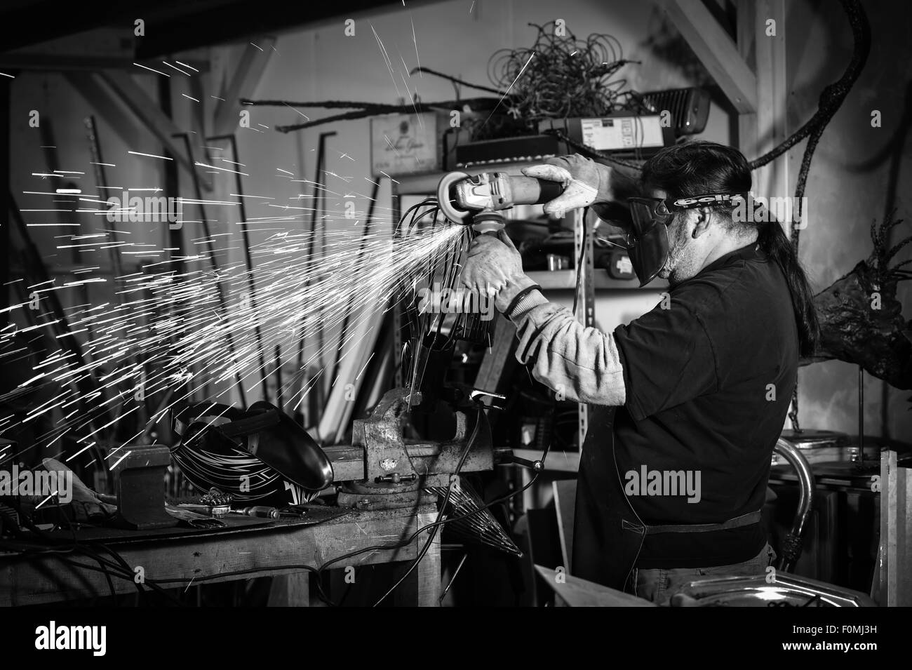 Metal worker Grinding with sparks in workshop Stock Photo - Alamy