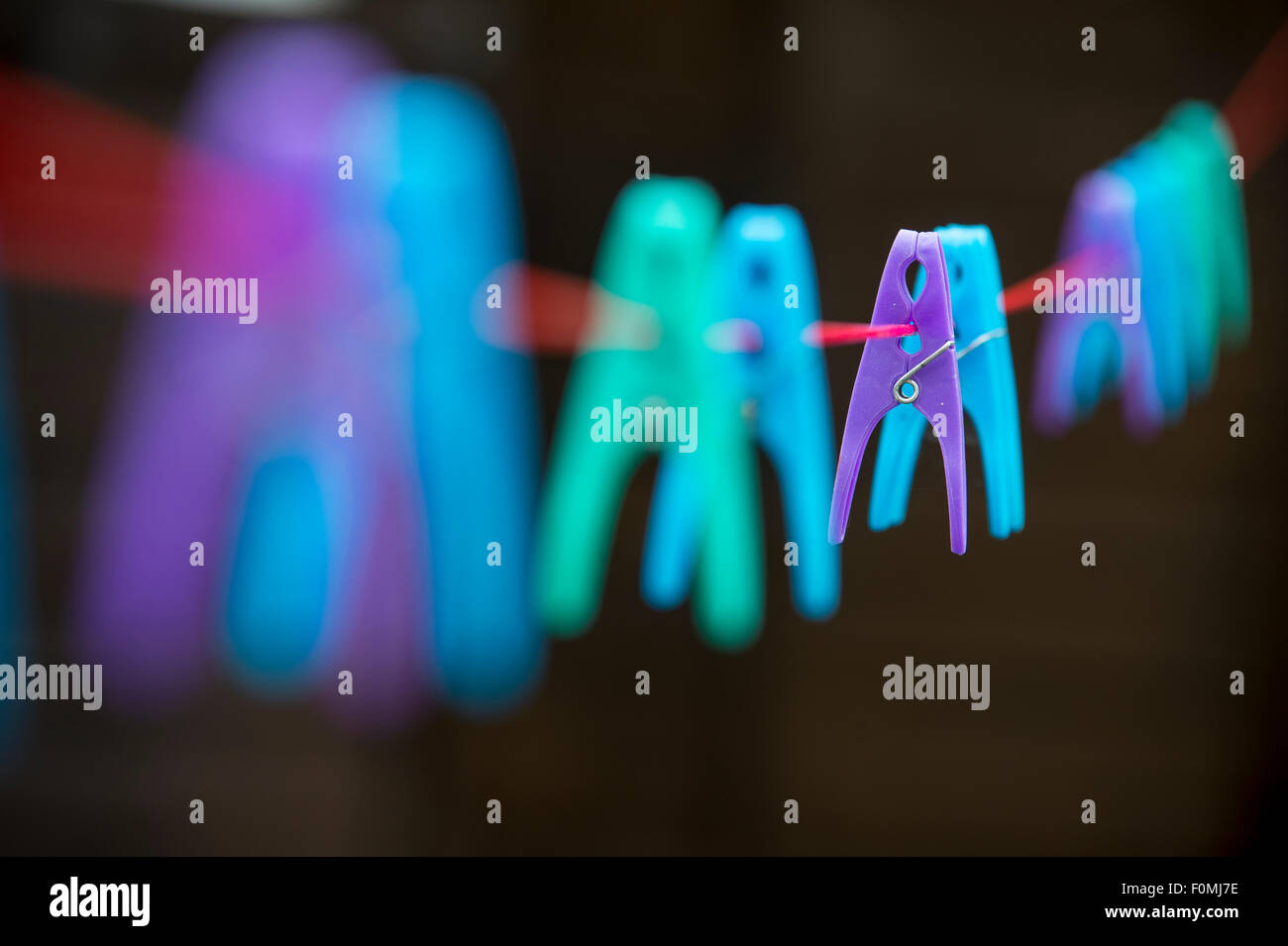 Multicolored pegs on a washing line Stock Photo - Alamy