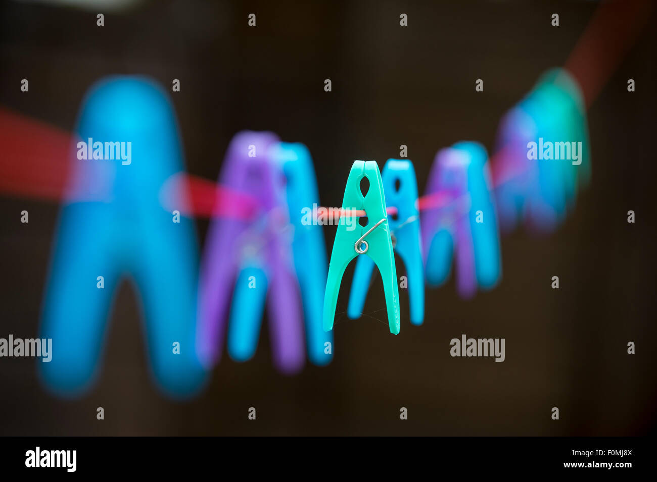 Multicolored pegs on a washing line Stock Photo - Alamy