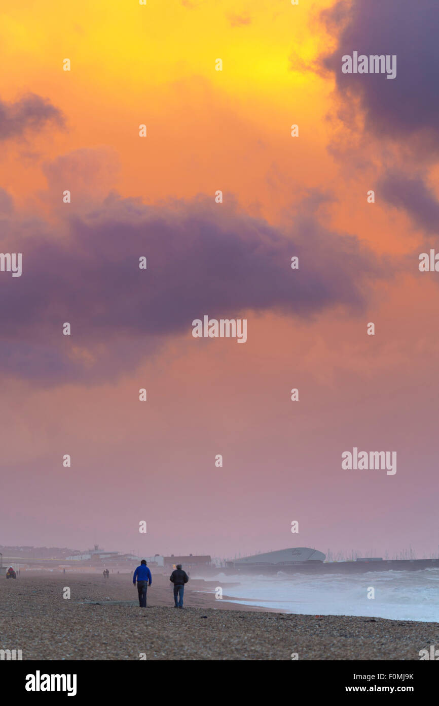 UK, East Sussex, Brighton, Two people walking along the beach in Kemp ...