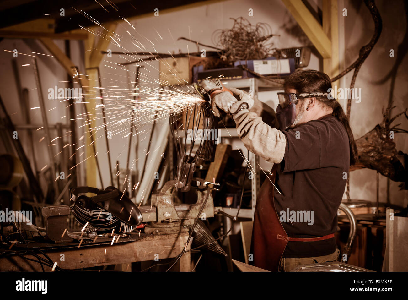 Metal worker Grinding with sparks in workshop Stock Photo - Alamy