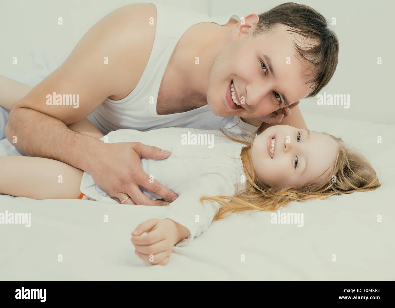 happy family, father and daughter in bed at home Stock Photo - Alamy
