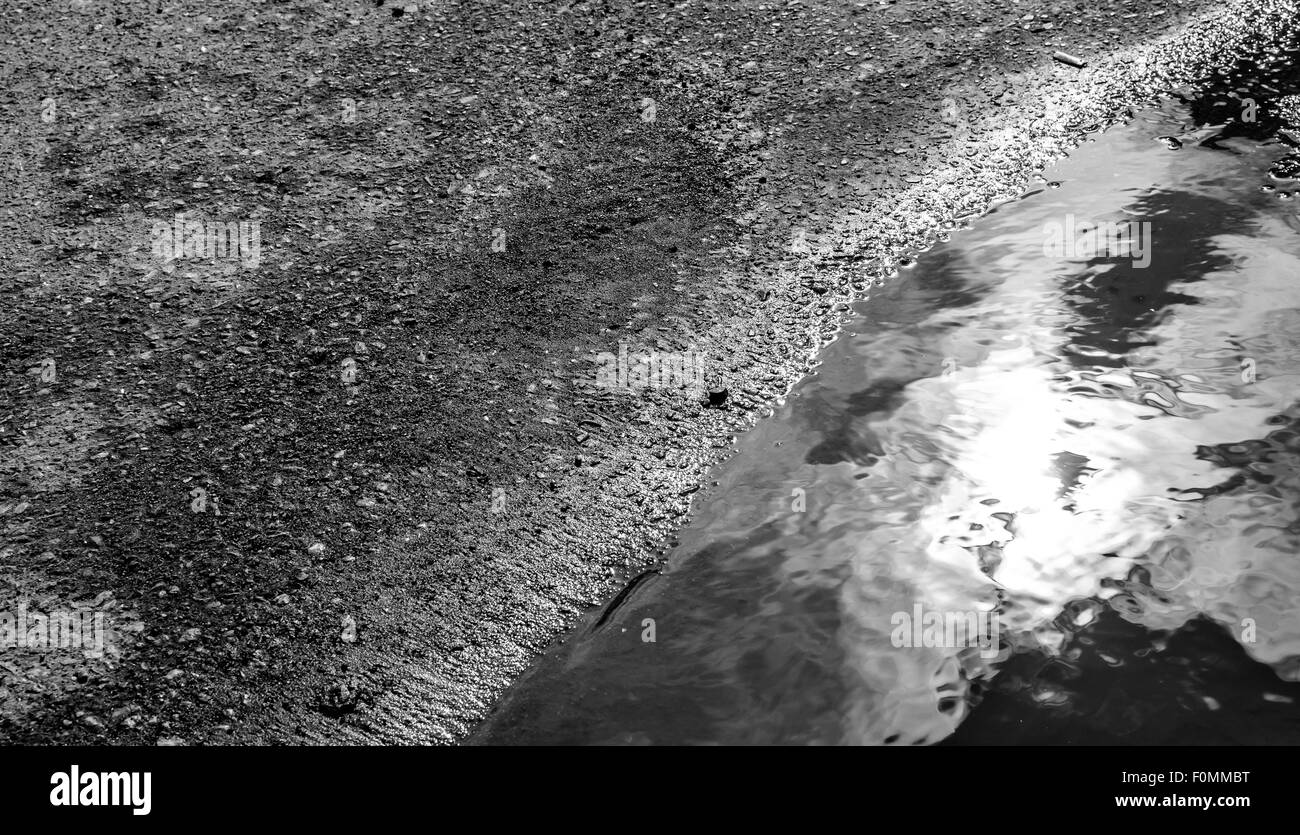 Sun reflection in a puddle of water after a rain storm Stock Photo - Alamy