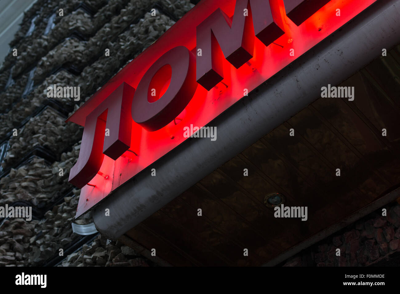Red neon bar sign in Russian Langauge marks the entrance to a club ...