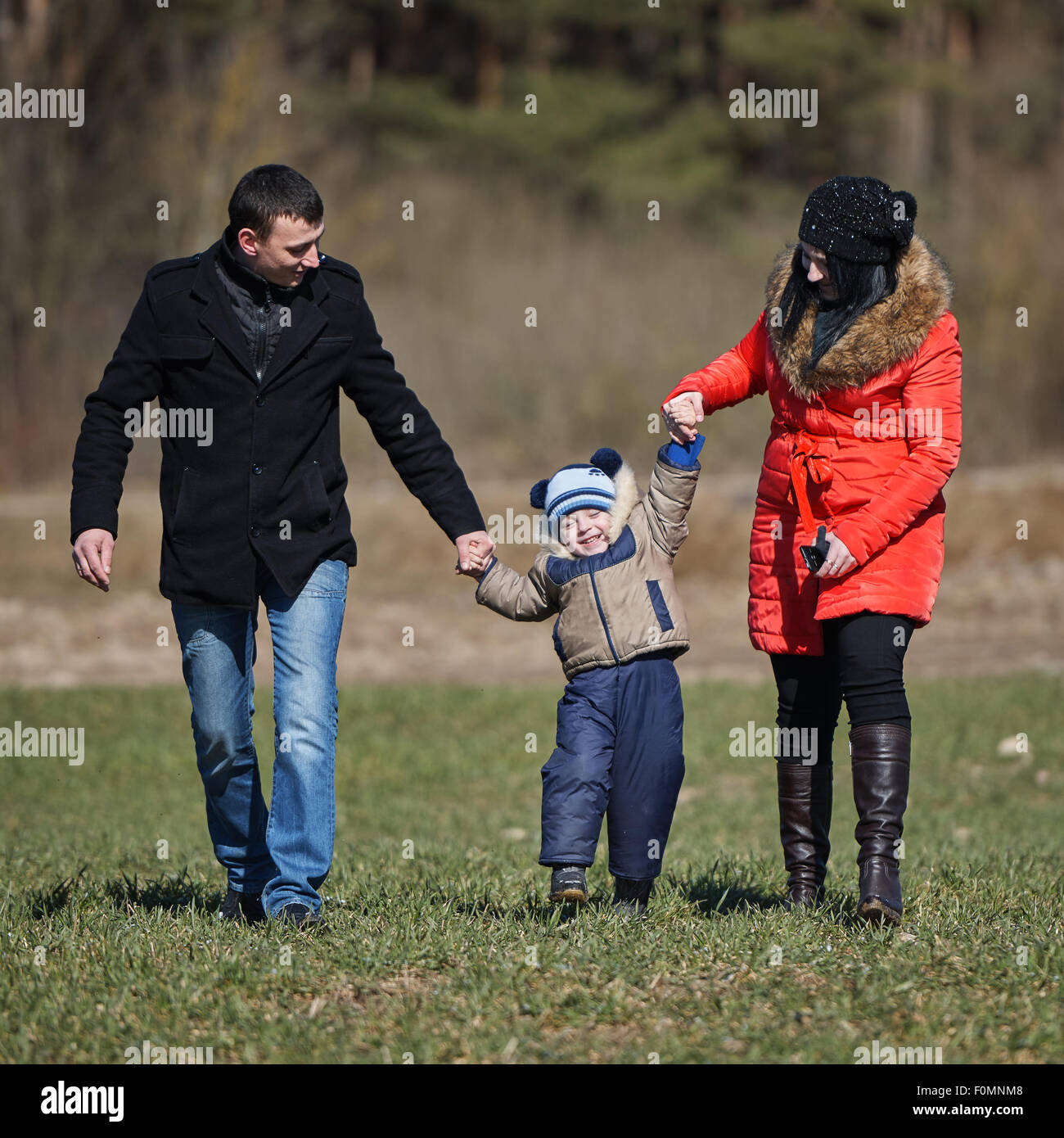 mom and dad raise child up Stock Photo - Alamy