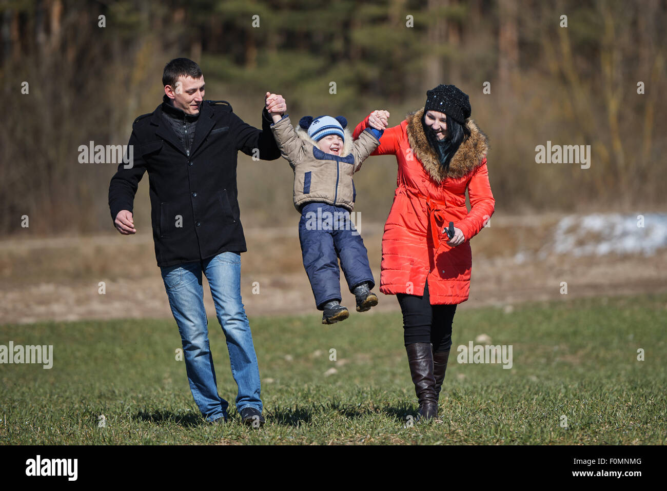 mom and dad raise child up Stock Photo - Alamy