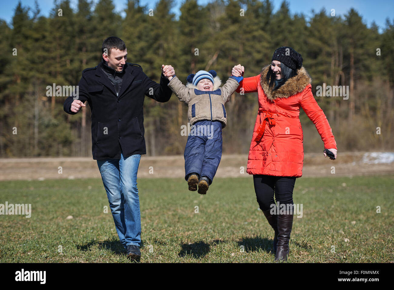 mom and dad raise child up Stock Photo - Alamy