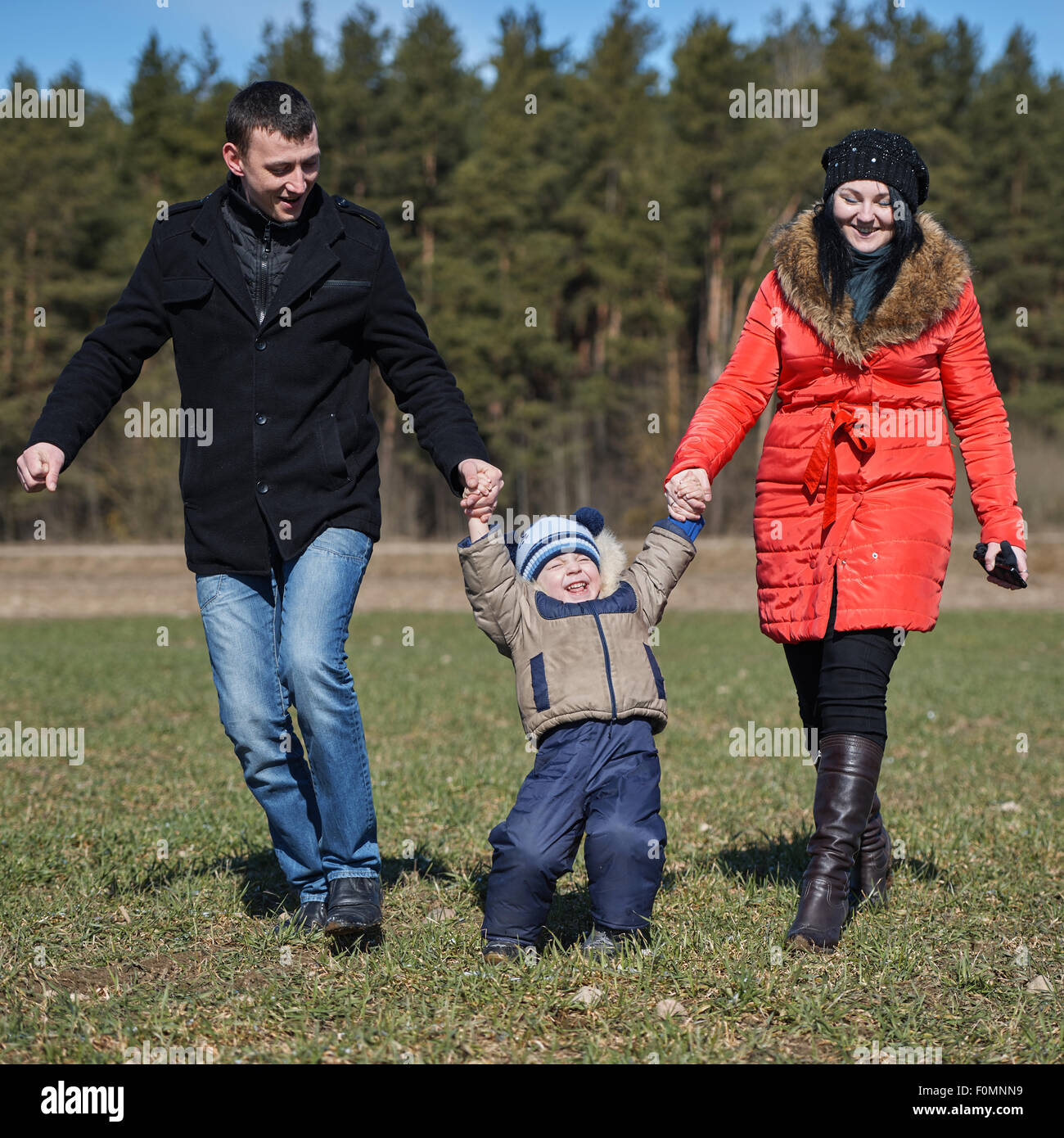 mom and dad raise child up Stock Photo - Alamy